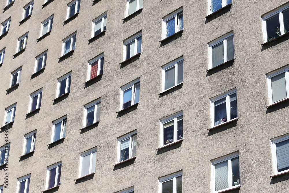 Residential building facade. Urban housing background with repetitive window pattern. Concrete ...