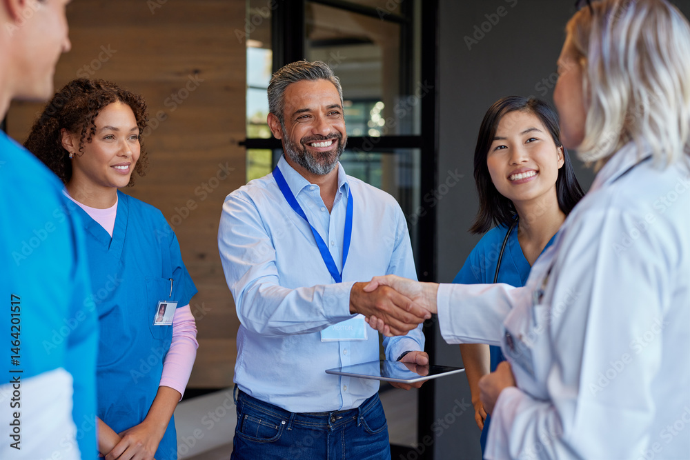 Mature woman doctor shaking hands with pharmaceutical representative at ...