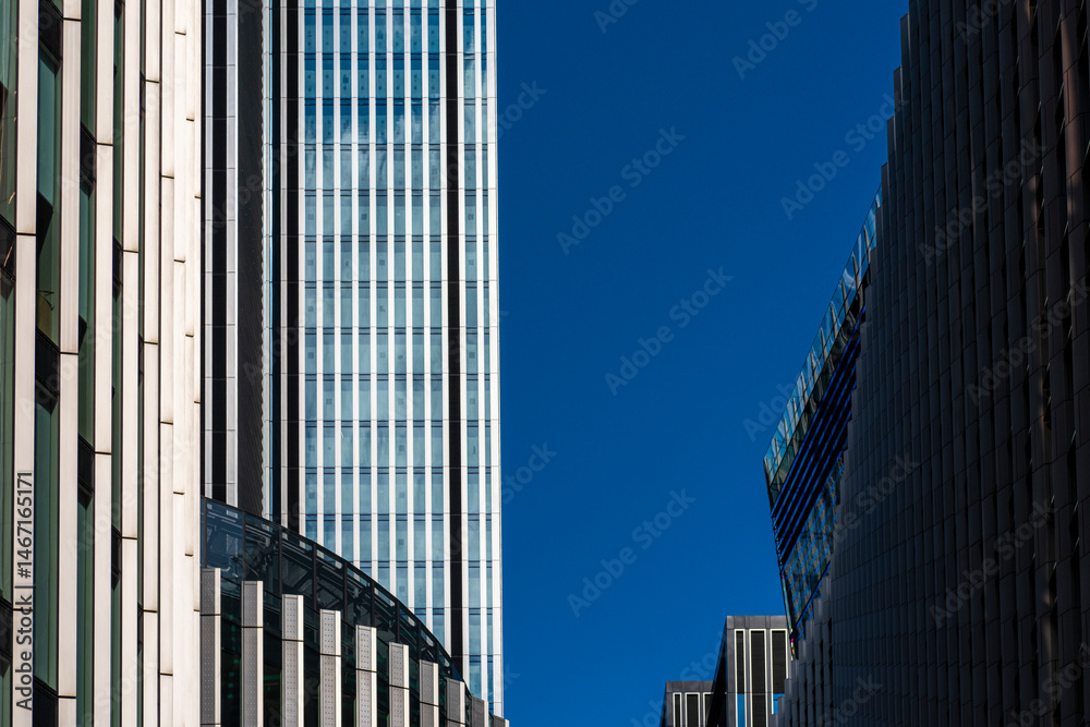 Facade contrast between steel cladding and glass towers, showcasing ...