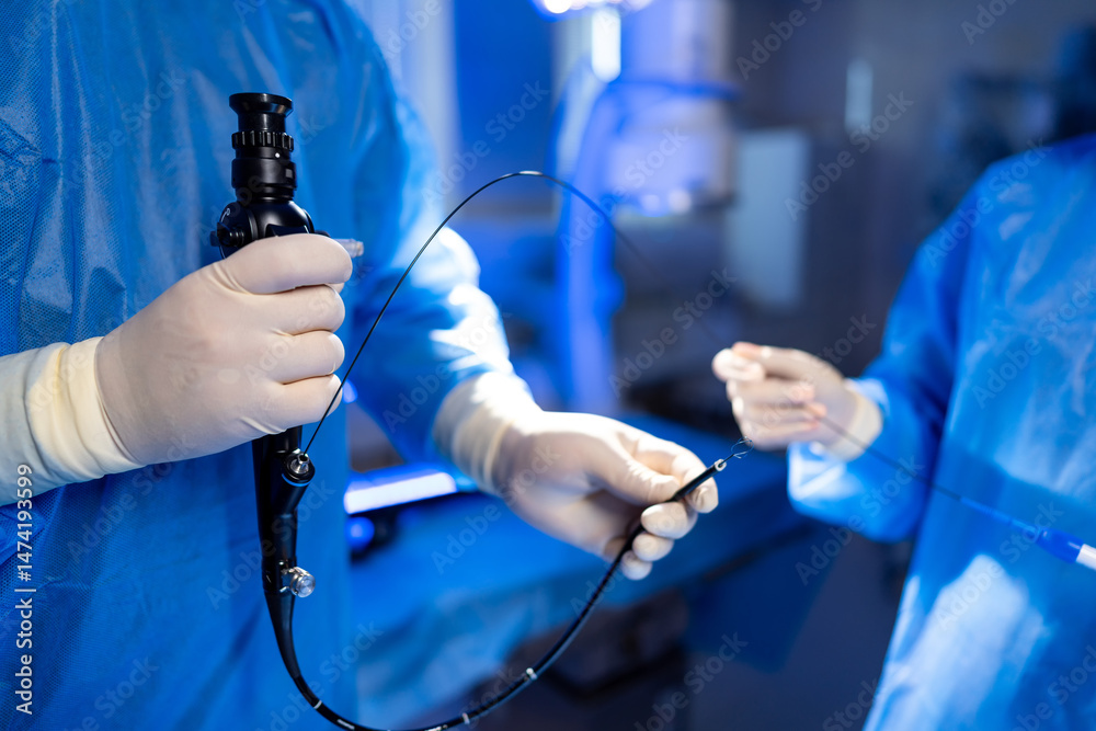 Team ready for endoscopy. Medical professionals in blue scrubs prepare ...