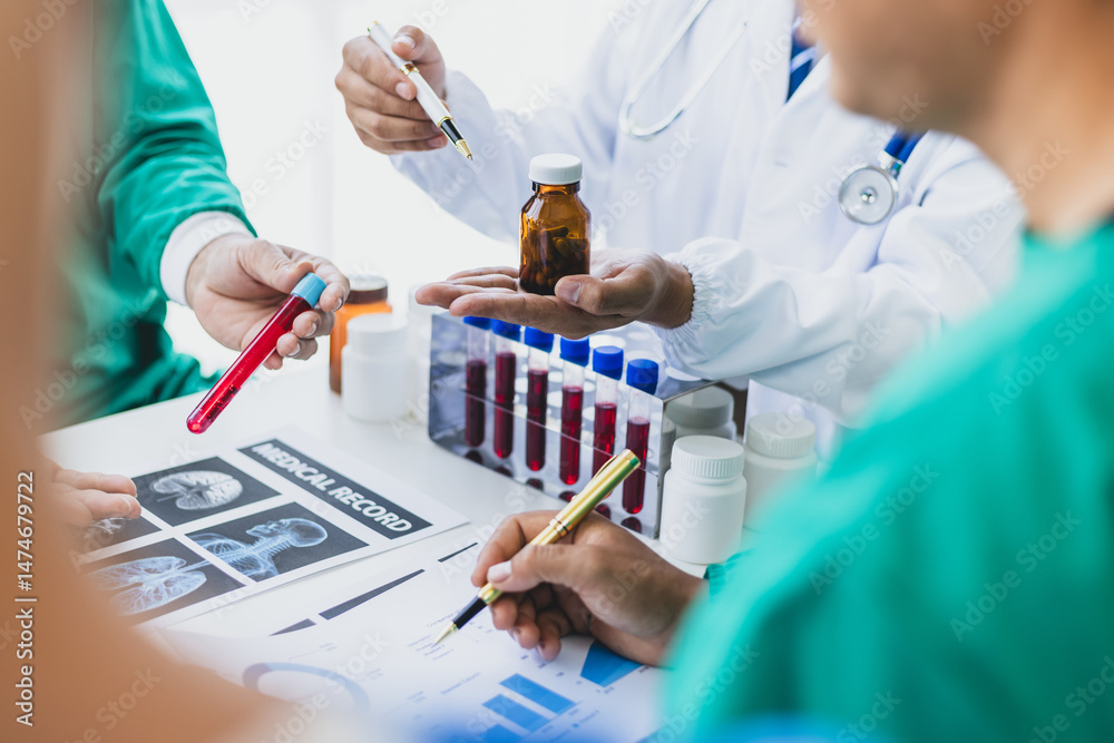 Medical team discussing diagnosis and treatment using x-ray and blood ...
