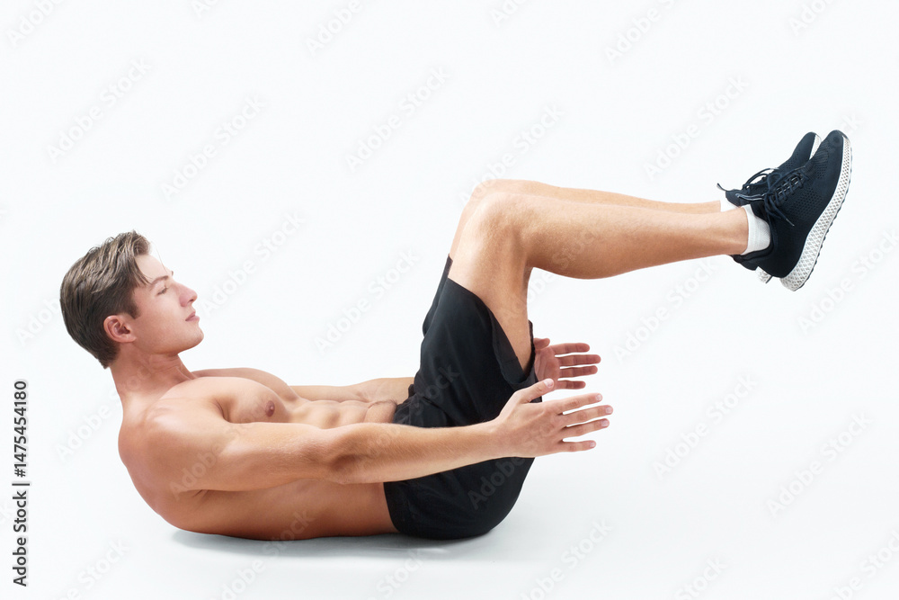 Side view of strong shirtless guy doing abs exercises, training his ...