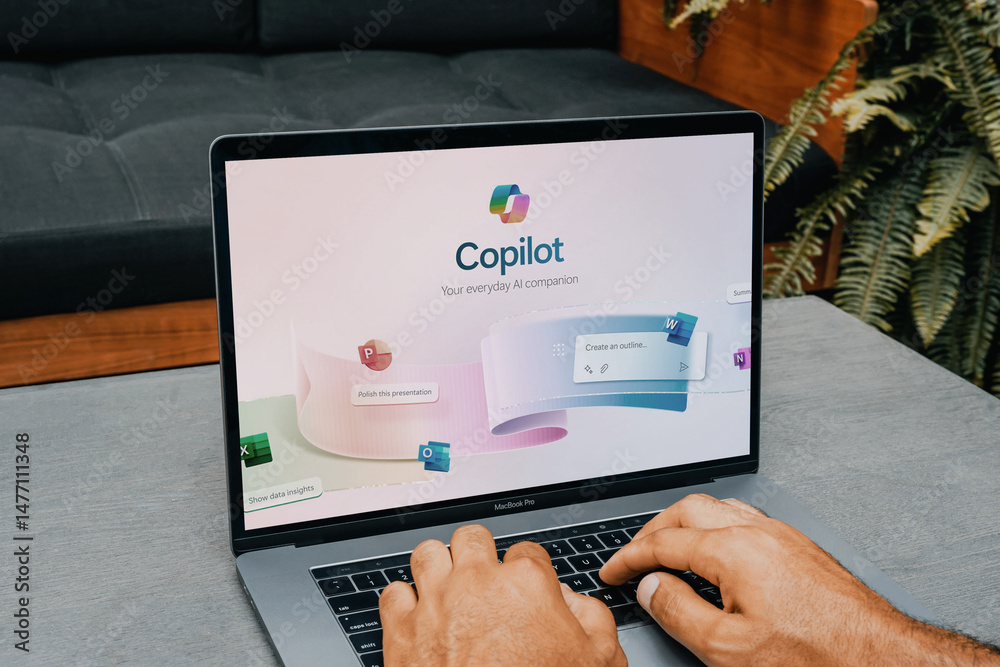 Office worker using copilot, microsoft's new ai companion, on a macbook ...