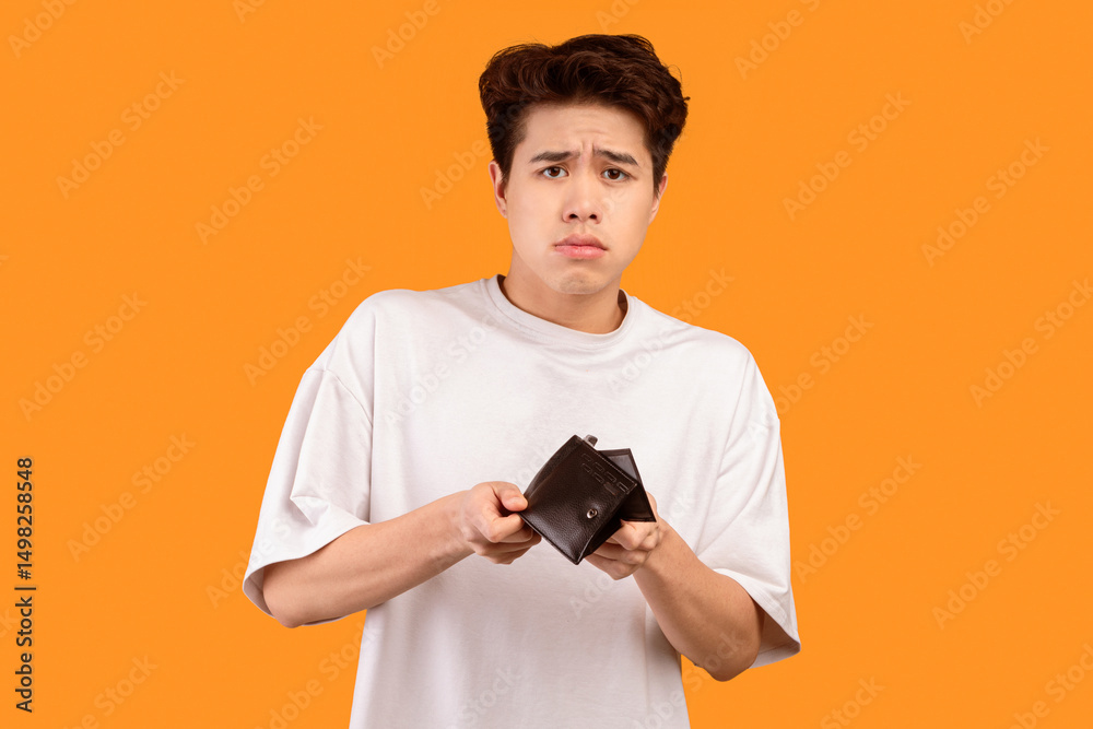 I'm Broke. Portrait of sad asian bankrupt showing his empty wallet and ...