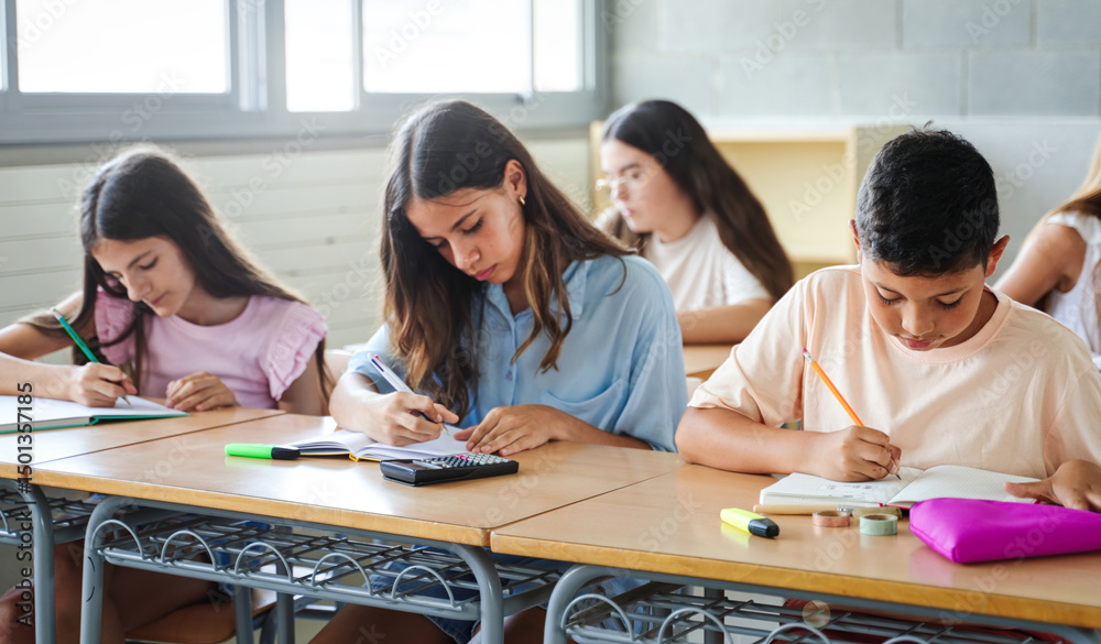 Elementary school students writing test in classroom at the primary ...
