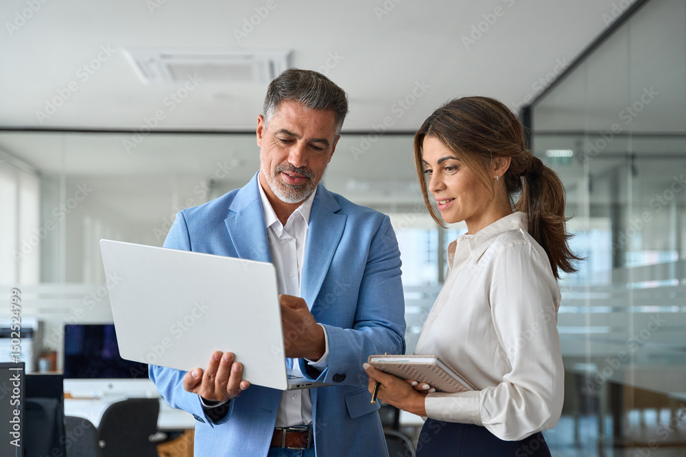 Busy professional smiling businessman and businesswoman leaders having conversation at work ...