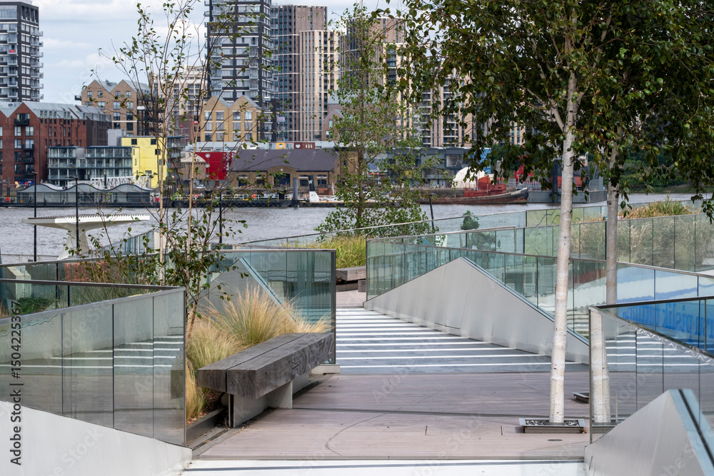 Minimalist urban park with concrete benches, trees and walkways ...