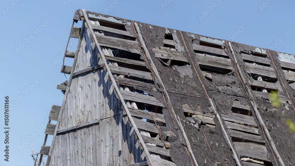 Foto de Stock Broken wooden roof with exposed rafters. Severely damaged ...