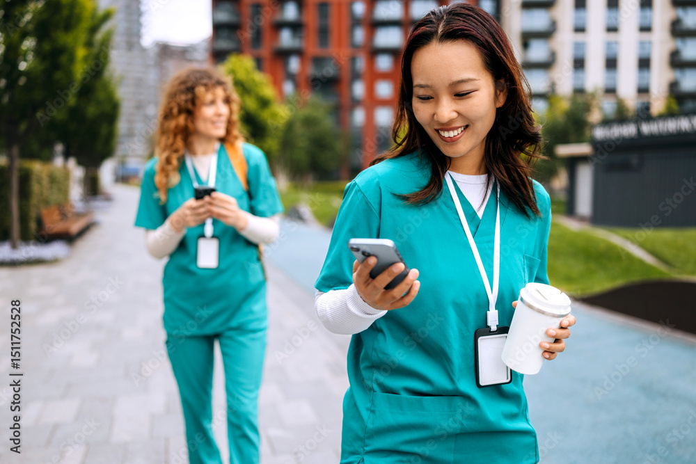 Healthcare professionals engage in conversation while walking in a ...