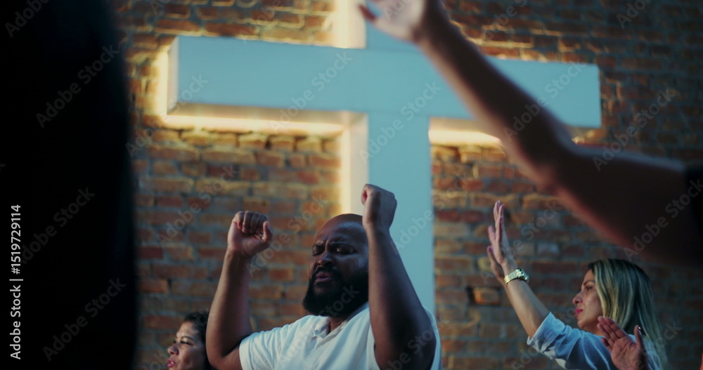 Congregation worshipping together, man raising hands with emotional ...