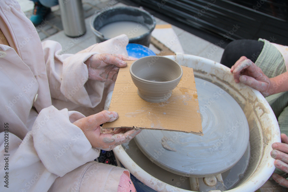 master class with children on clay modeling on a potter's wheel. hands ...