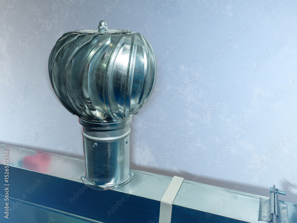Rotating turbine ventilator on a metal duct enhances air circulation ...