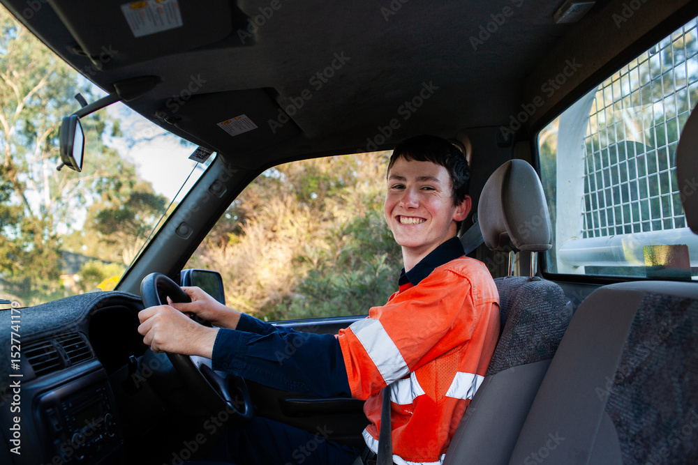 Young teenaged Australian driver driving ute in country wearing high ...