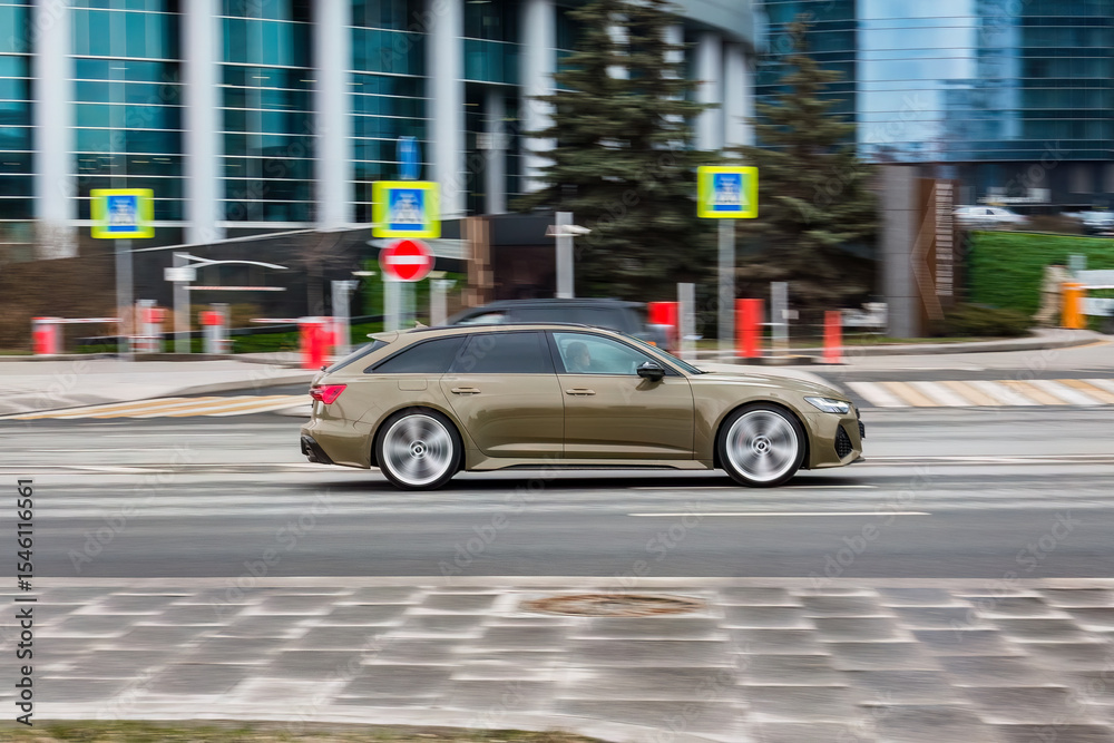 Sage Green Audi RS6 car moving fast on city street, side view Stock ...
