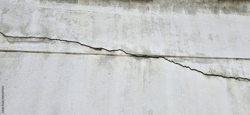 Cracks in old cement wall were visible as wide crack fissures. This may ...