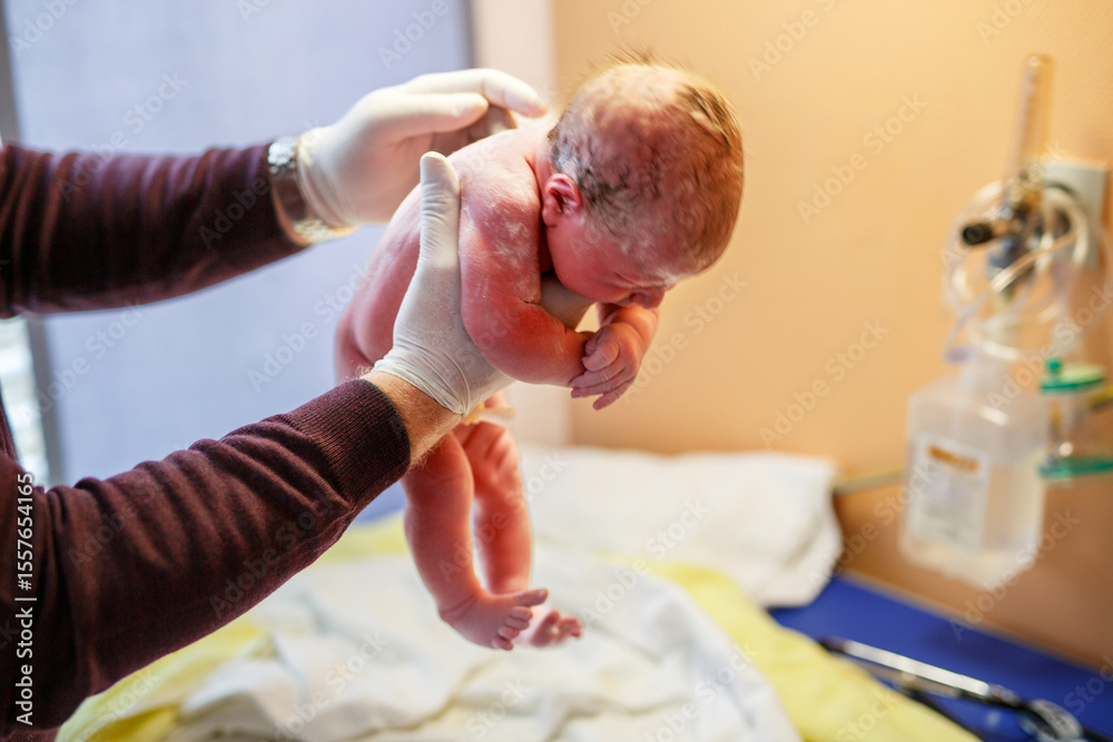 Newborn child seconds and minutes after birth. Doctor hands with new ...