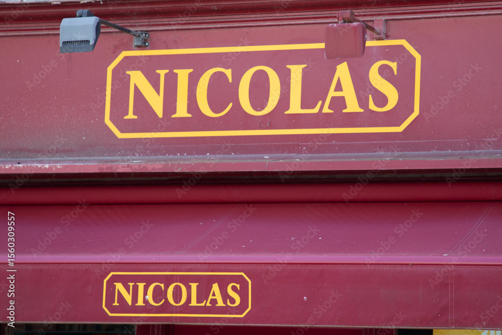 nicolas logo brand and text sign wall chain facade shop storefront of ...