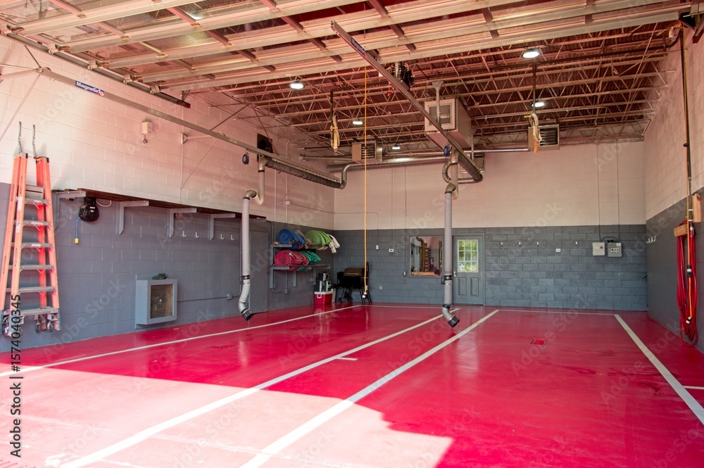 Empty bay at fire station with red floor Stock Photo | Adobe Stock