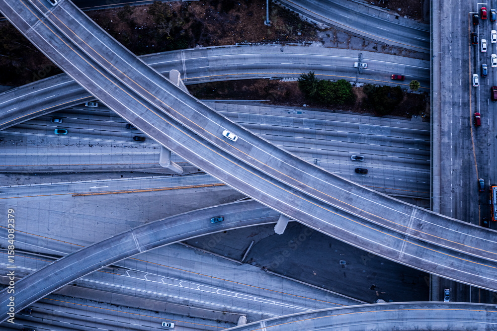 Aerial view of layered freeway overpasses in Los Angeles at twilight ...