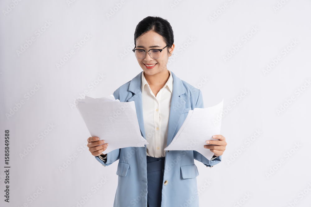 Professional woman reviewing documents in a light blue suit against a ...
