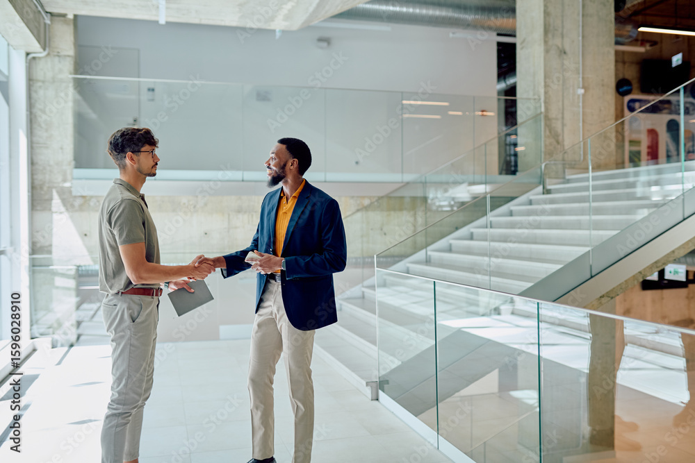 Two businessmen engaging in a handshake after a successful negotiation ...