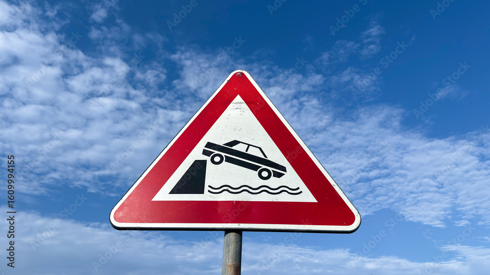 Road sign warning of the danger of falling into the water on an ...