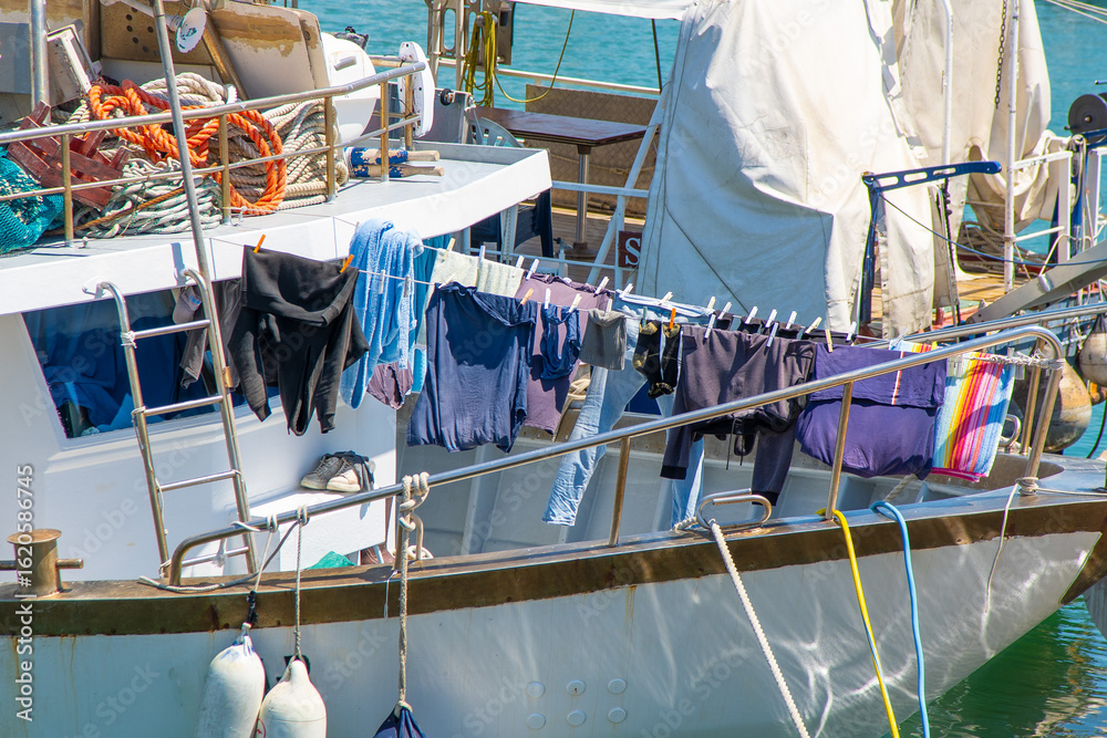 Life on a boat. Washing clothes on a yacht. Clothes drying on a rope ...