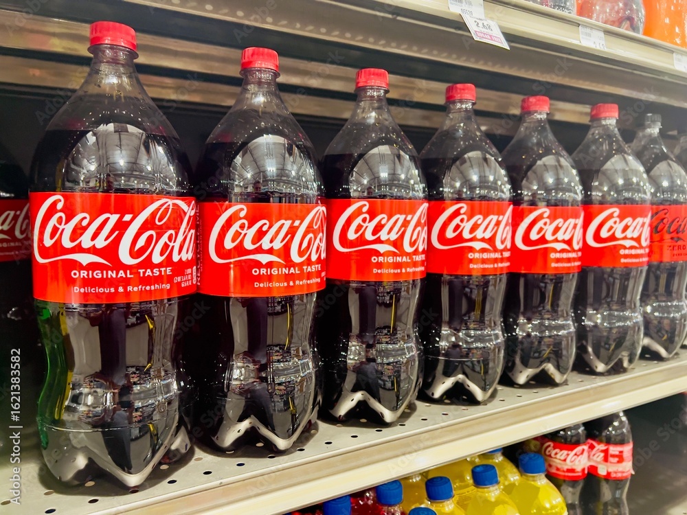 Plastic bottles of coca cola brand sodas for sale in a supermarket ...