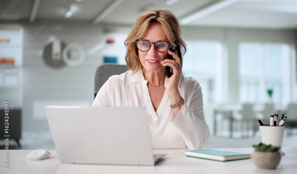 Successful Senior Businesswoman Speaking With Client On Smartphone ...