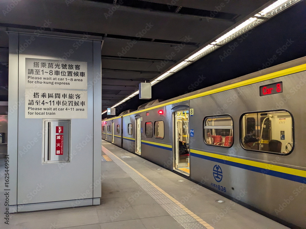 Taiwan Railways local train stopped at a station platform with ...