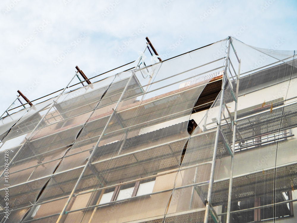 Residential apartment building during facade repair or renovation with ...