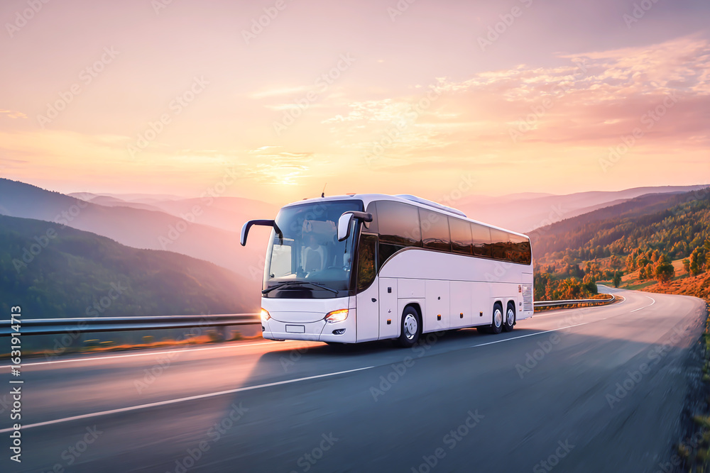 A white, modern, luxury coach bus driving on a highway road in a ...