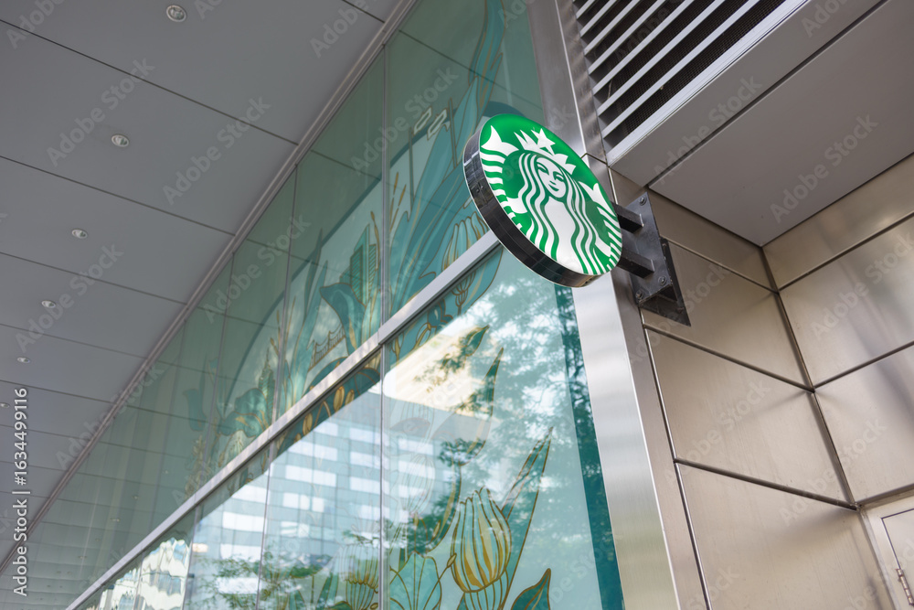 round projecting sign outside Starbucks, a coffee shop chain, located ...