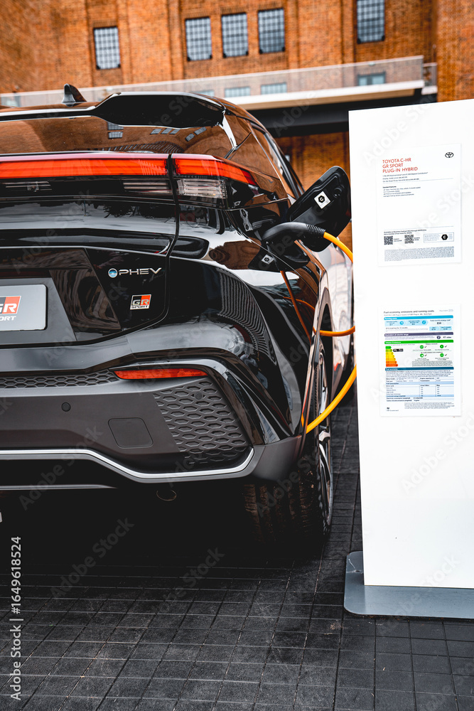 Foto stock di Toyota C-HR Hybrid SUV Plugged, Public EV Charging Station, Electric Vehicle ...