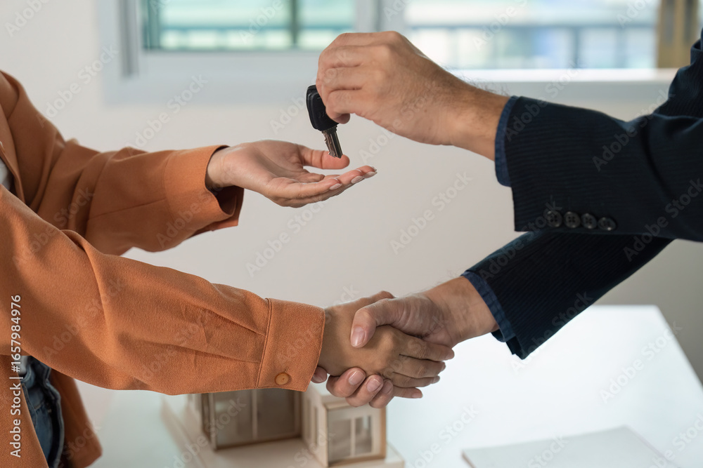 Key Handover in Real Estate. Agent giving keys to buyer after handshake ...