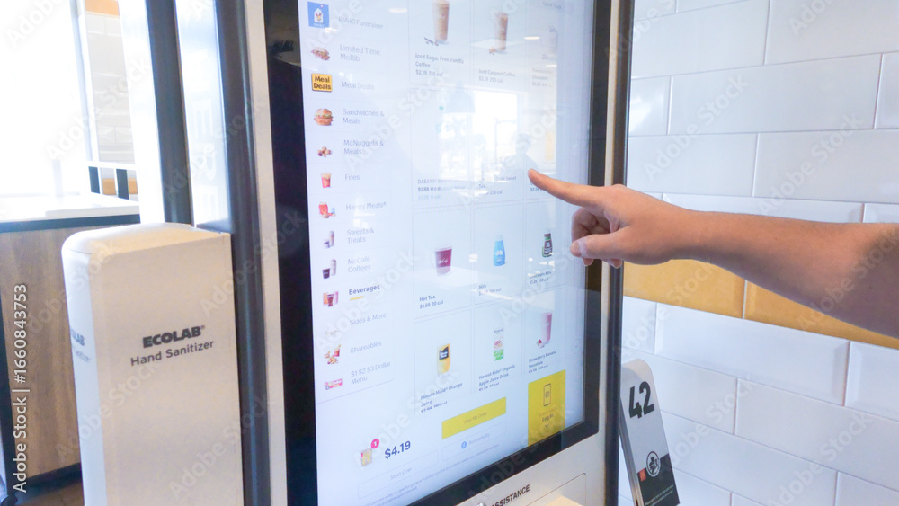 McDonald's digital menu display with hand interacting, showcasing food ...