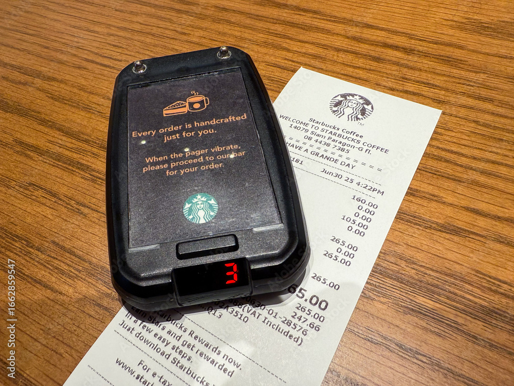 Bangkok, Thailand - June 30, 2025: Starbucks queue pager and receipt on ...