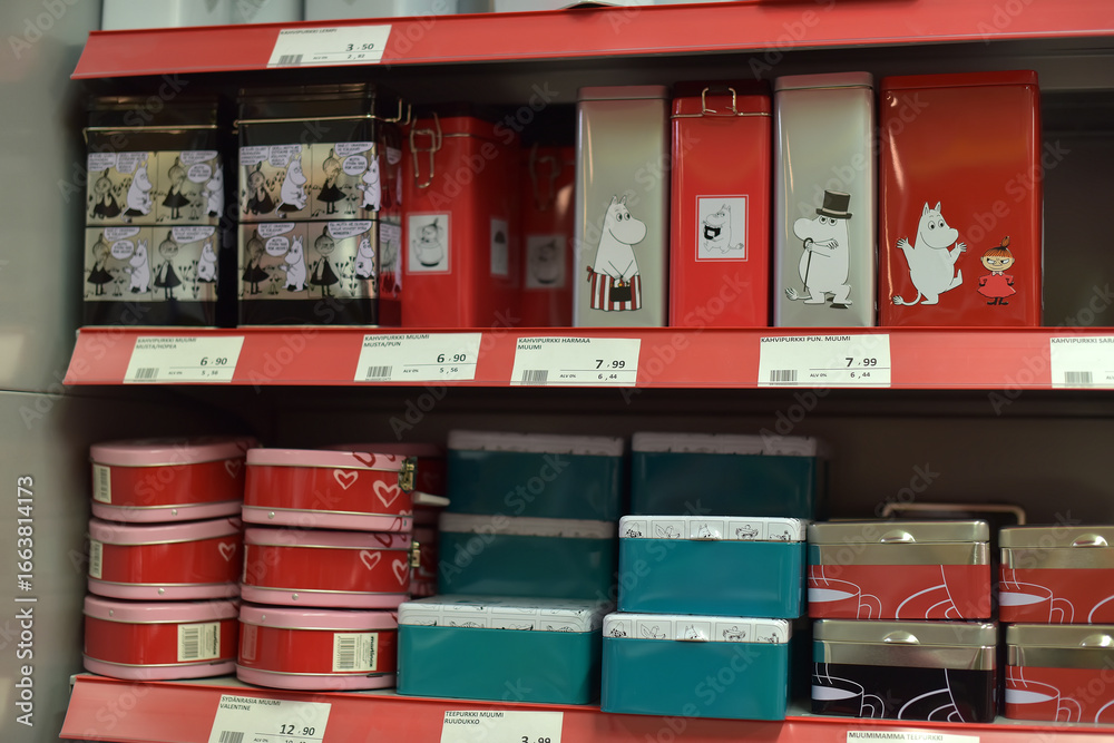 shelves in a store with metal cans and boxes with images of characters ...