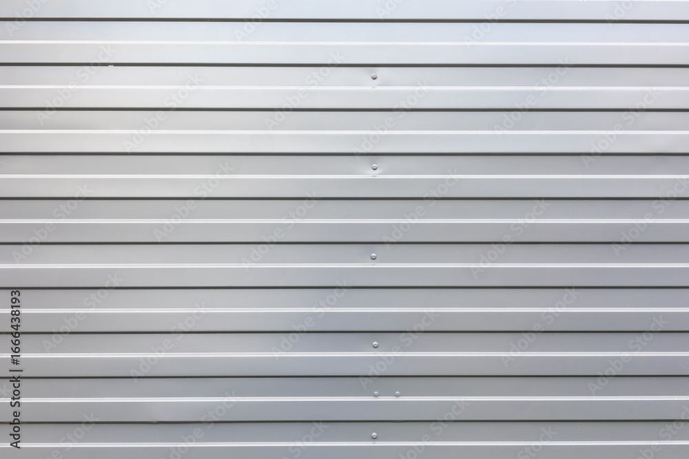 Metallic siding wall with horizontal lines and screw heads. Industrial ...