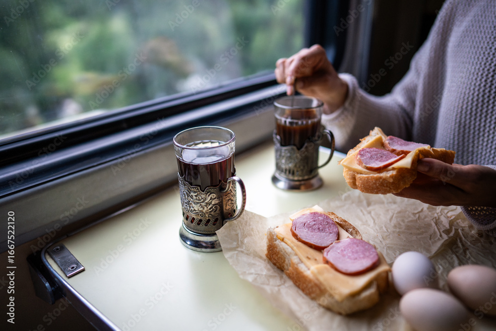 Стоковое фото «Passenger have lunch in train car by window, travel ...