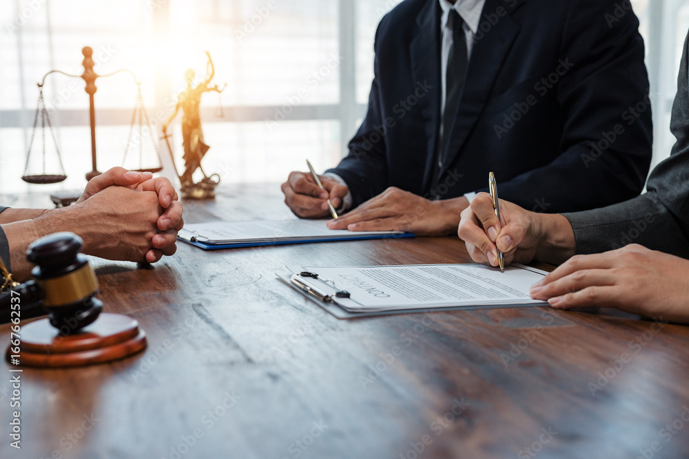 Business professionals engaged in signing a contract while ...