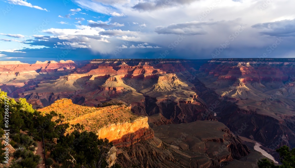 Panoramic vista of the Grand Canyon during golden hour illuminating ...