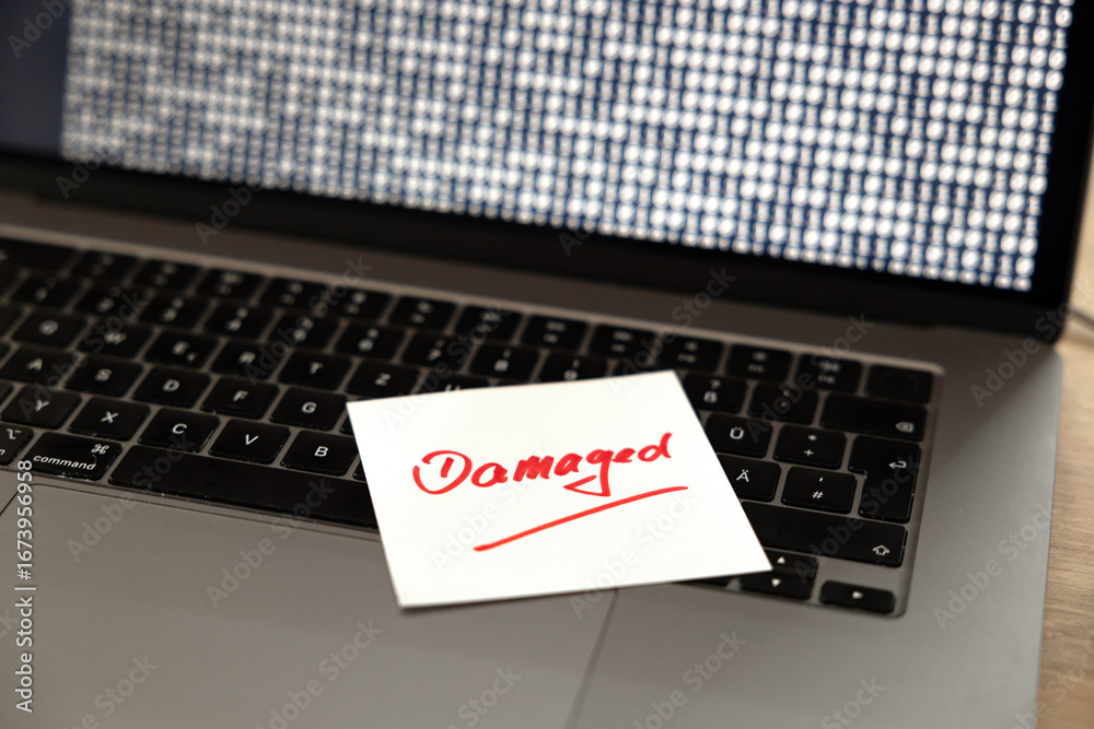 Computer damaged, note on the keyboard of a laptop. Warning, defect ...