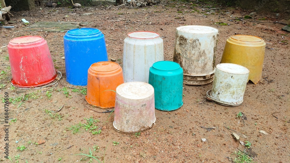 Stock-Foto „Bunch of old damaged plastic buckets and containers ...