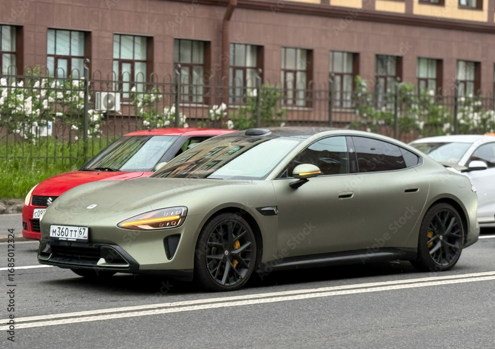 Xiaomi SU7 green color parked at the city street side view. Exterior of ...