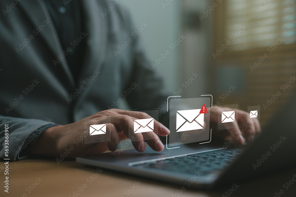 Businessman checking email notifications on laptop with alert icon ...