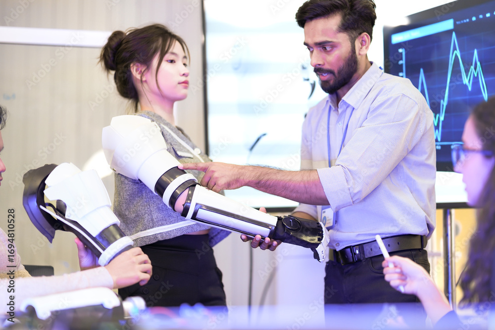 Bio-mechanical engineers test a myoelectric prosthetic arm on a user ...