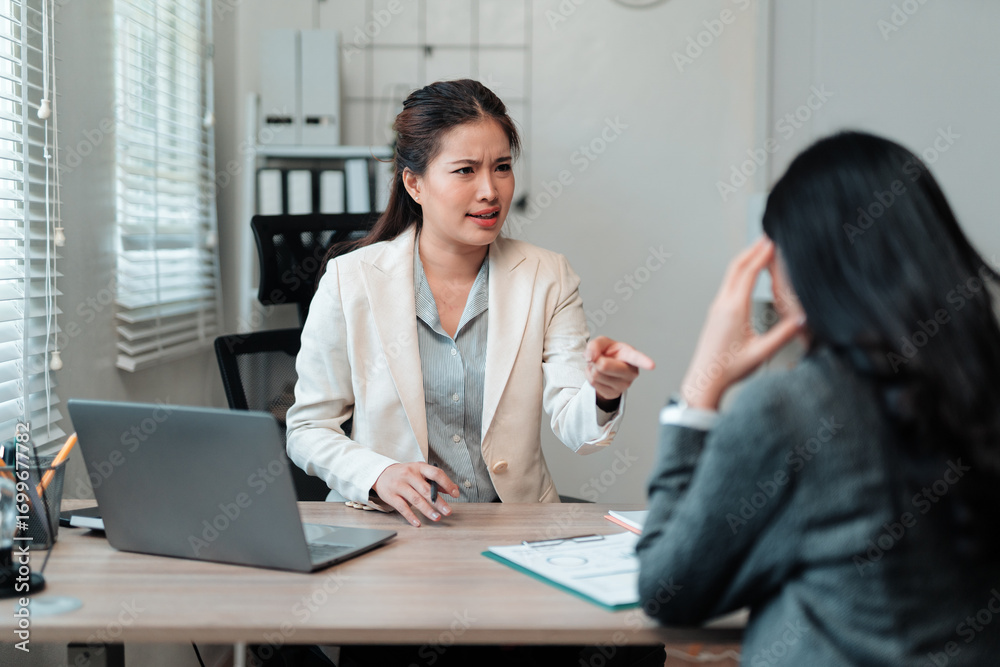 Asian businesswomen arguing about project results, conflict at work and ...