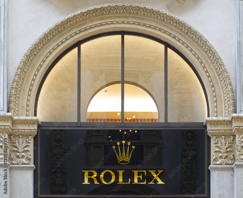 Exterior of the Rolex luxury watch store with golden crown logo. Milan ...