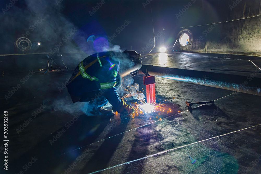 Welding male worker metal is part of machinery plate bottom tank sump ...